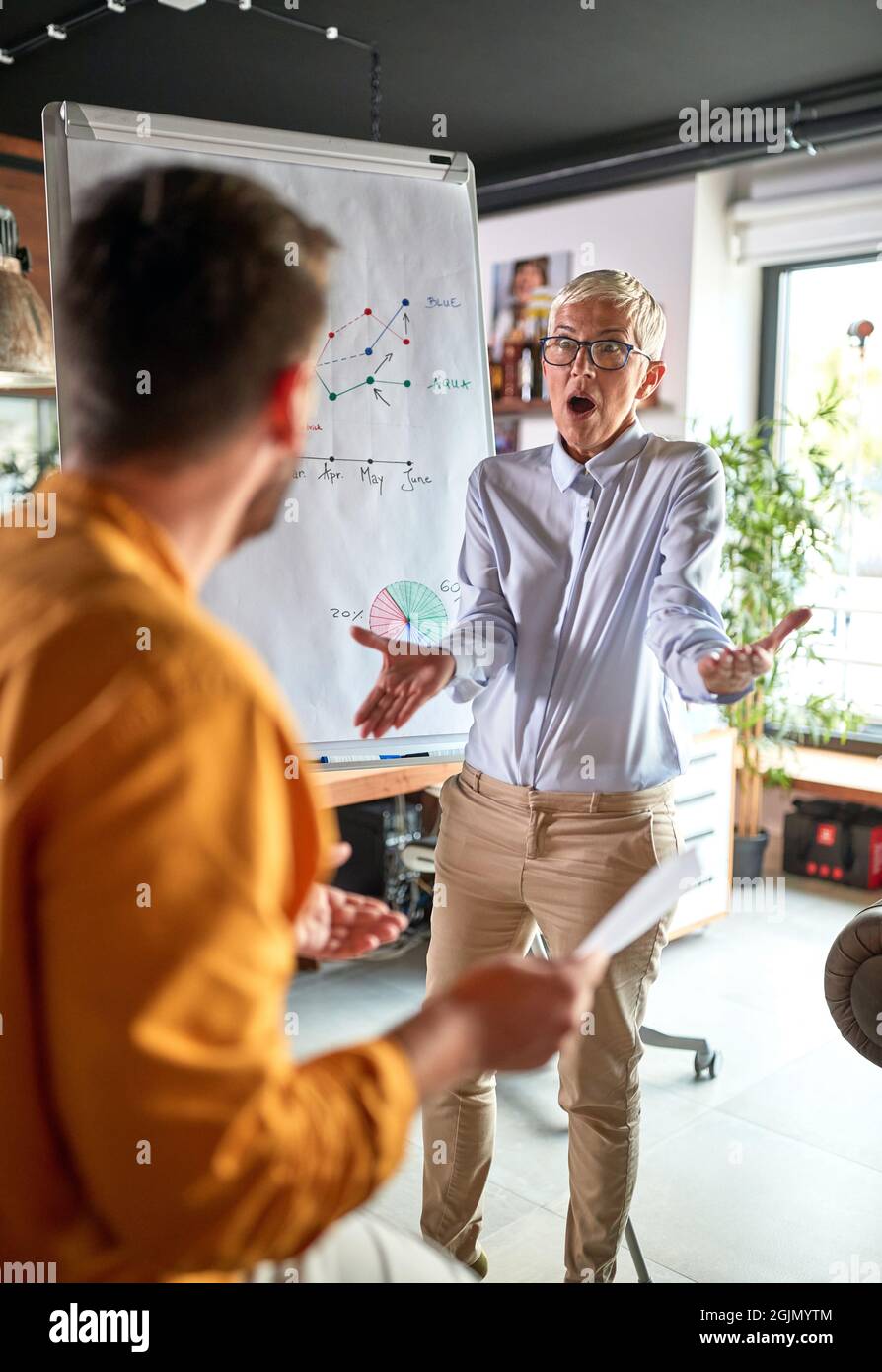 Colleagues debating office hi-res stock photography and images - Alamy