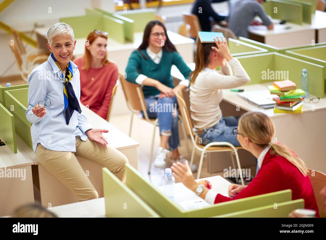 Female professor and students having good time at the lecture in a ...