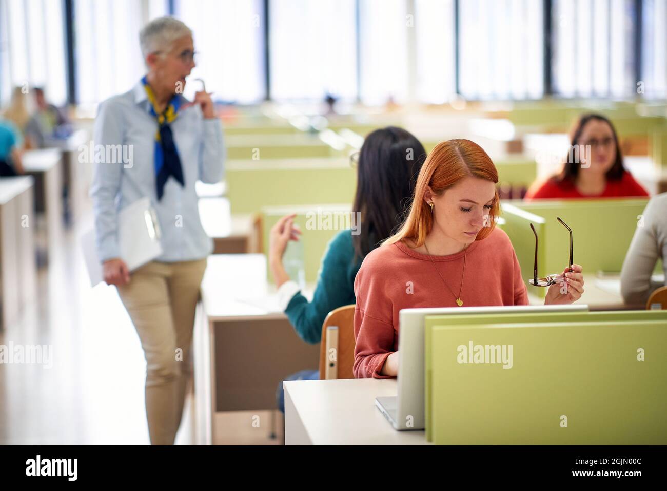 Female student reading a lesson at a lecture in a classroom Stock Photo ...