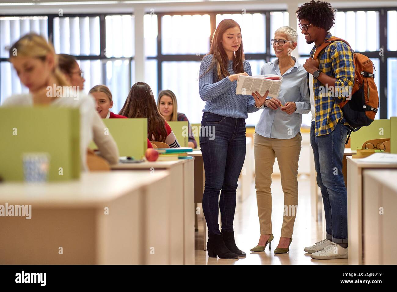 A female professor giving a help a student about new lesson in the ...