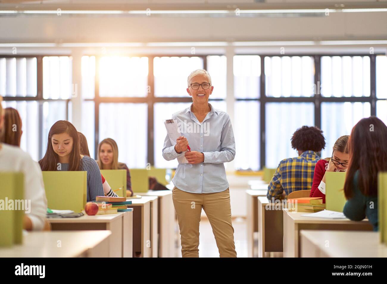 Female professor and students at the lecture in the classroom Stock ...