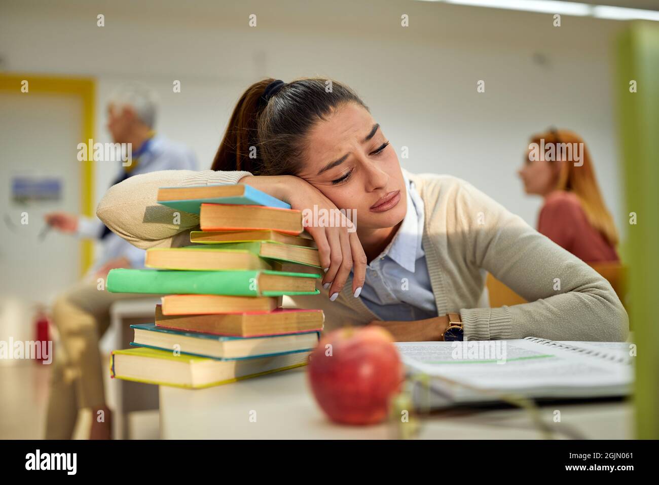 Exhausted female student at the lecture break in the university ...