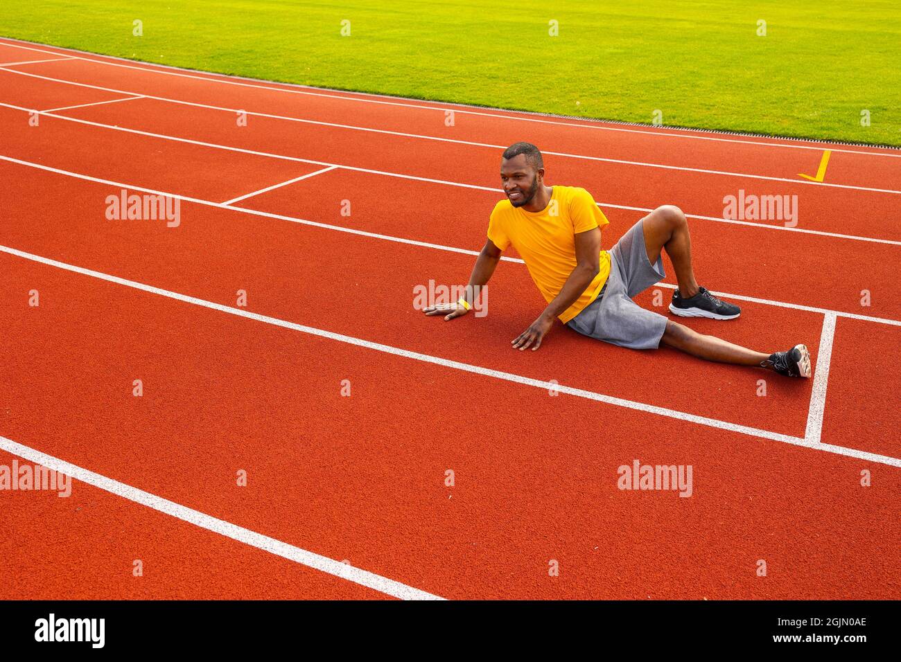 Happy african american male working out at the stadium track, smiling ...