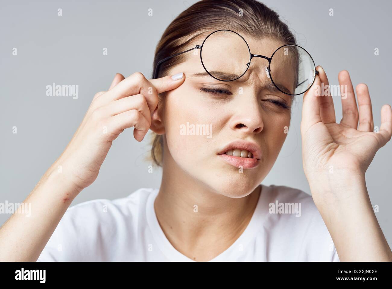 woman in white t-shirt glasses poor eyesight close-up Stock Photo - Alamy