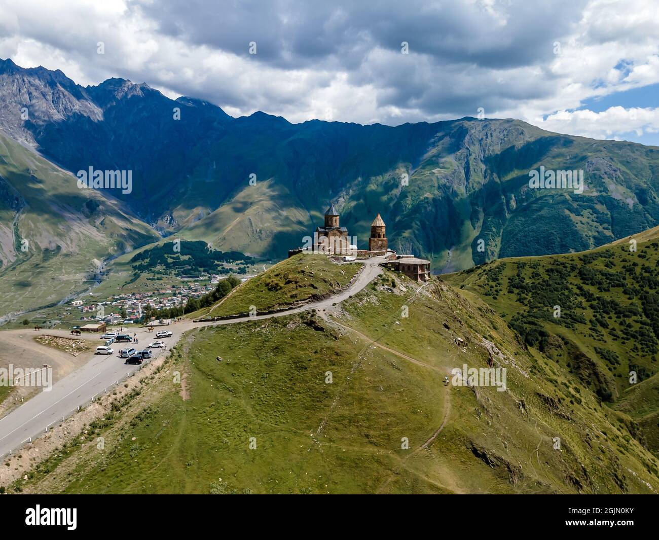 Aerial view of Gergeti Trinity Monastery on a beautiful mountain in ...