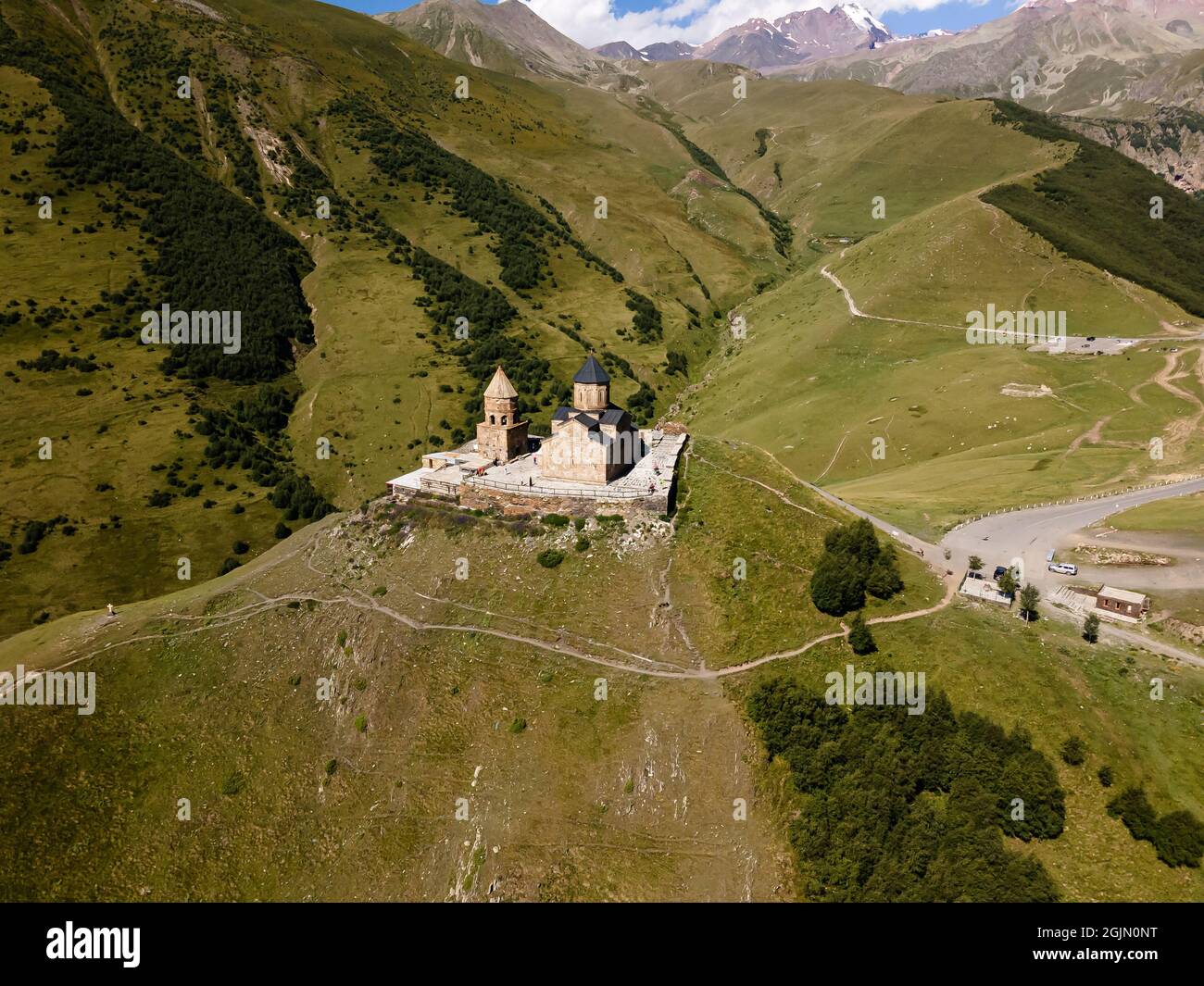 Aerial view of Gergeti Trinity Monastery on a beautiful mountain in ...