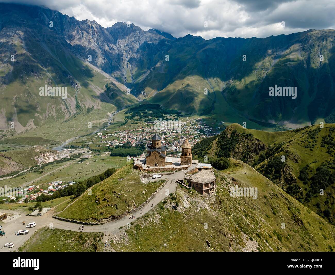 Aerial view of Gergeti Trinity Monastery on a beautiful mountain in ...