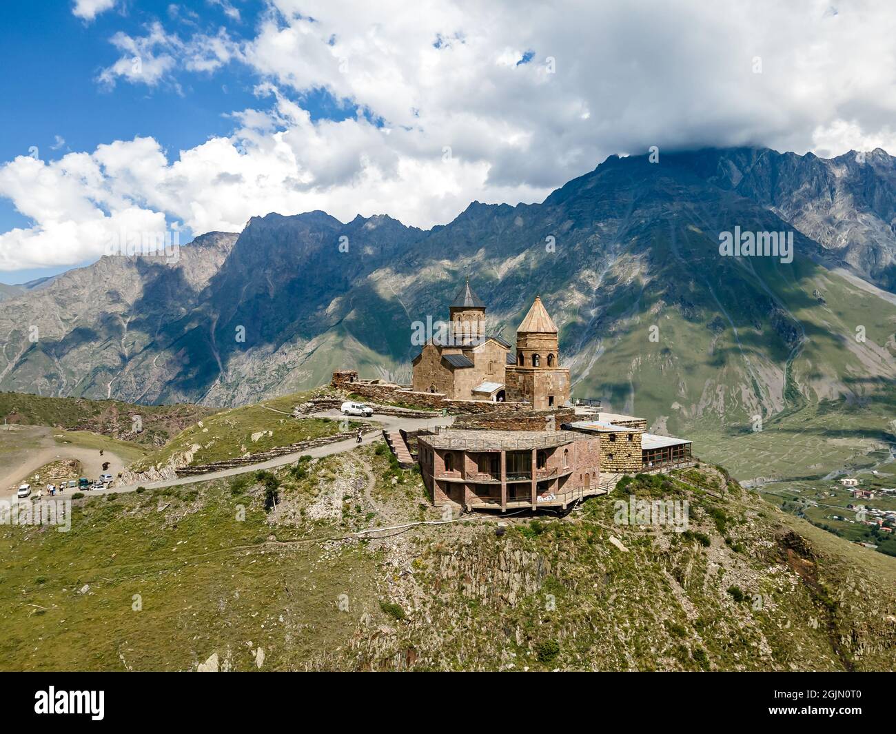 Aerial view of Gergeti Trinity Monastery on a beautiful mountain in ...