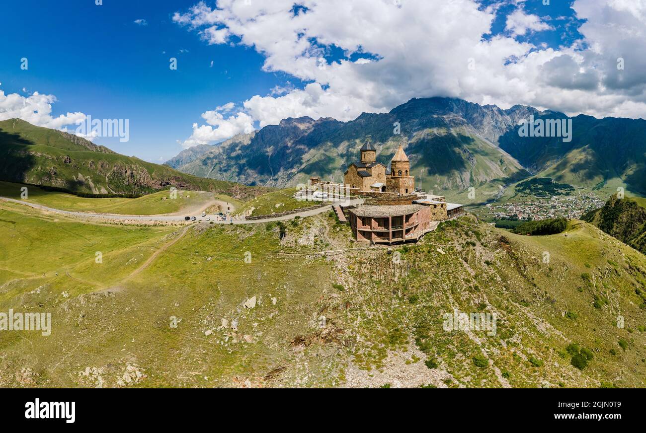 Aerial view of Gergeti Trinity Monastery on a beautiful mountain in ...