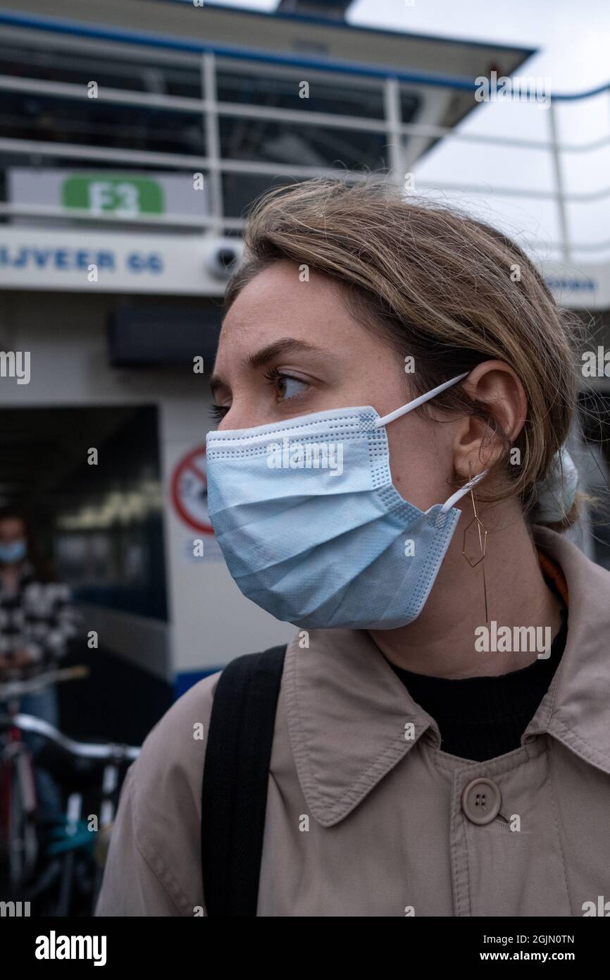 The Netherlands, Amsterdam, summer 2021. Person wearing a face mask ...