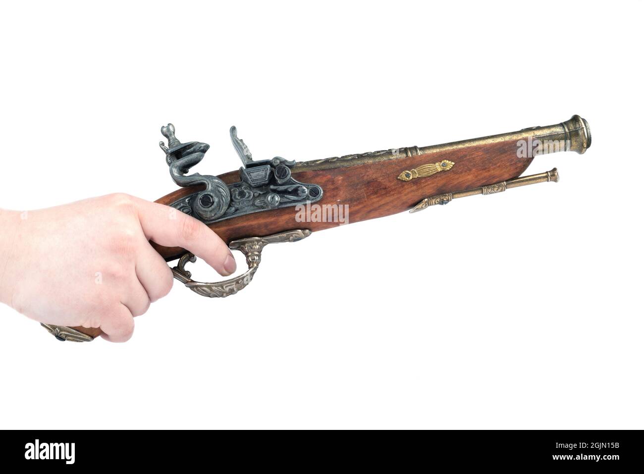 Human hand on the trigger of a mock-up of an old pistol. Copy space ...