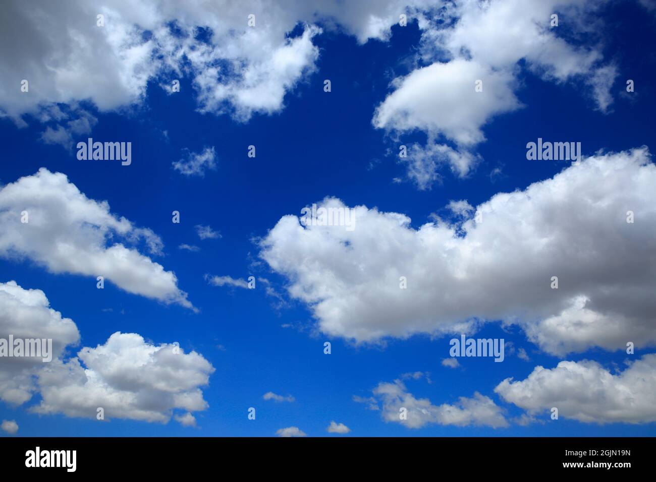 Spectacular landscape with white clouds in a clean and dark blue sky ...