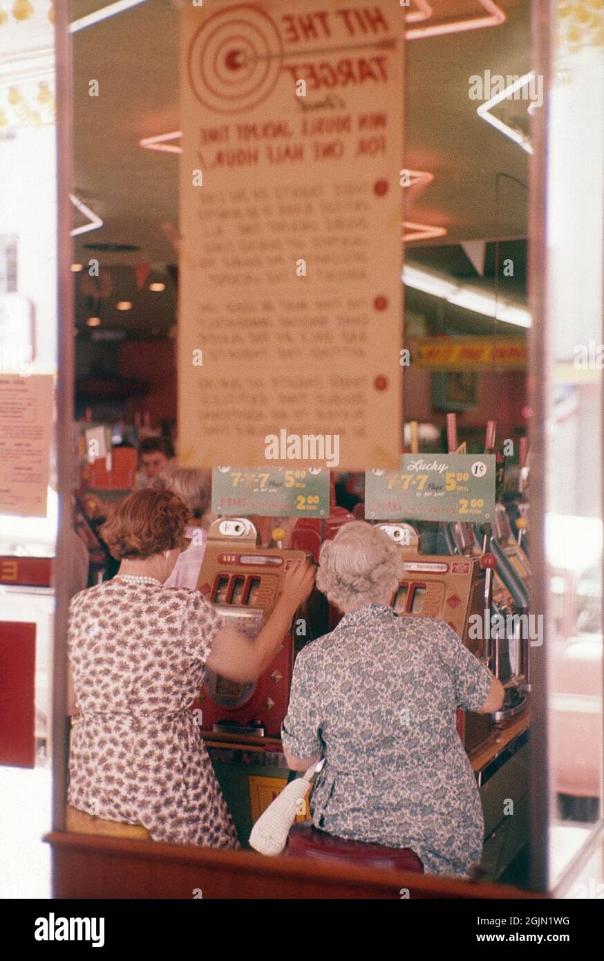 Las Vegas 1959. Anonymous women pictured from behind at slot machines ...