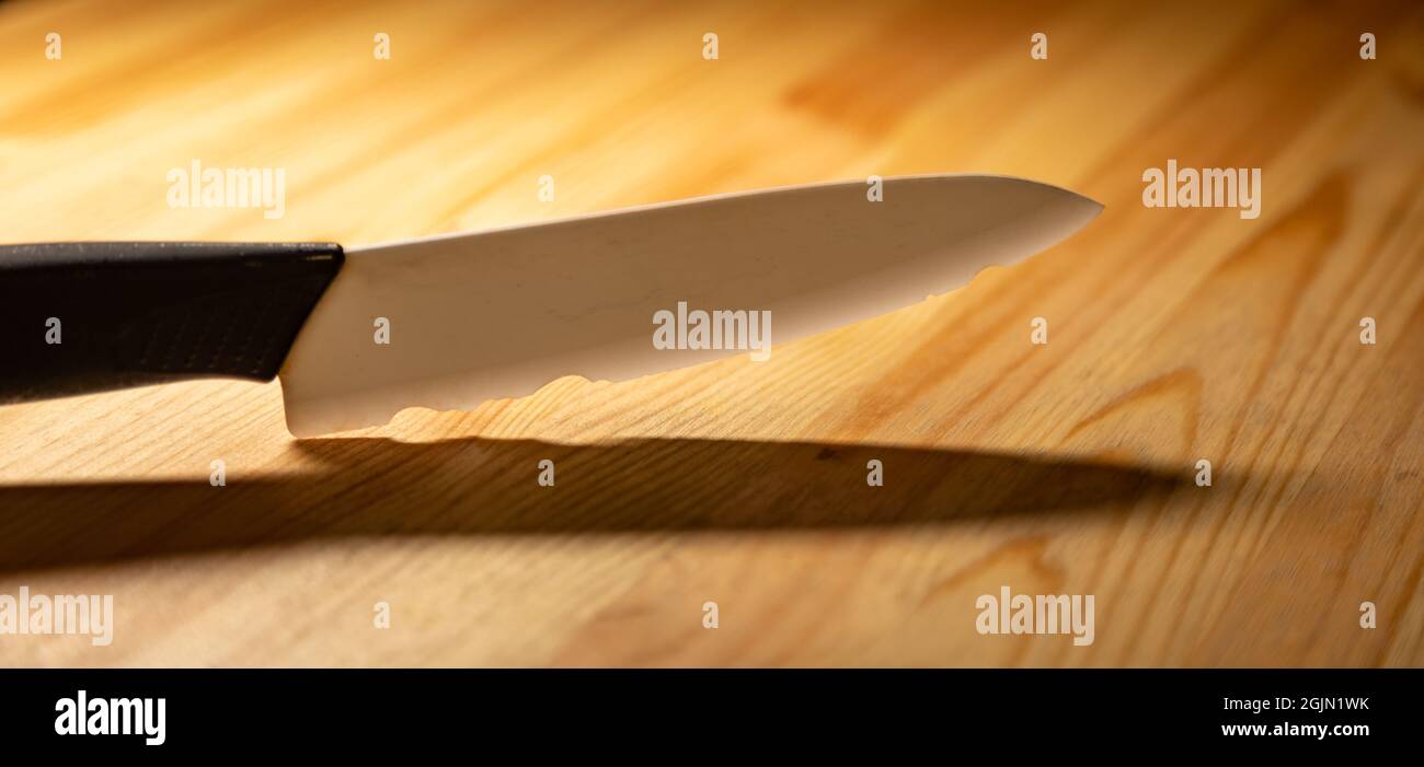 close up old white ceramic knife with a chipped blade. broken ...