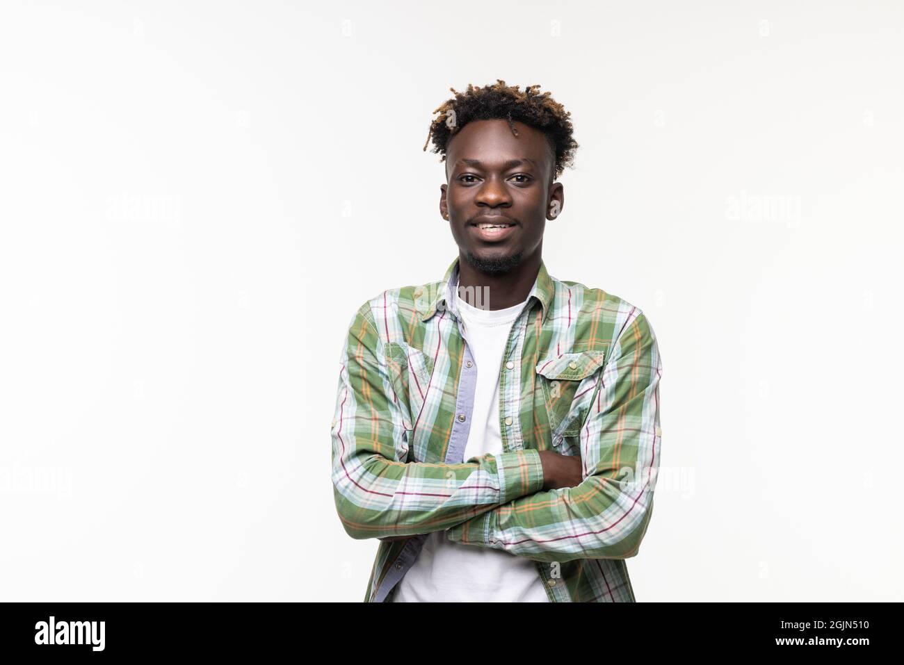 Smiling african man with crossed arms on white background Stock Photo ...