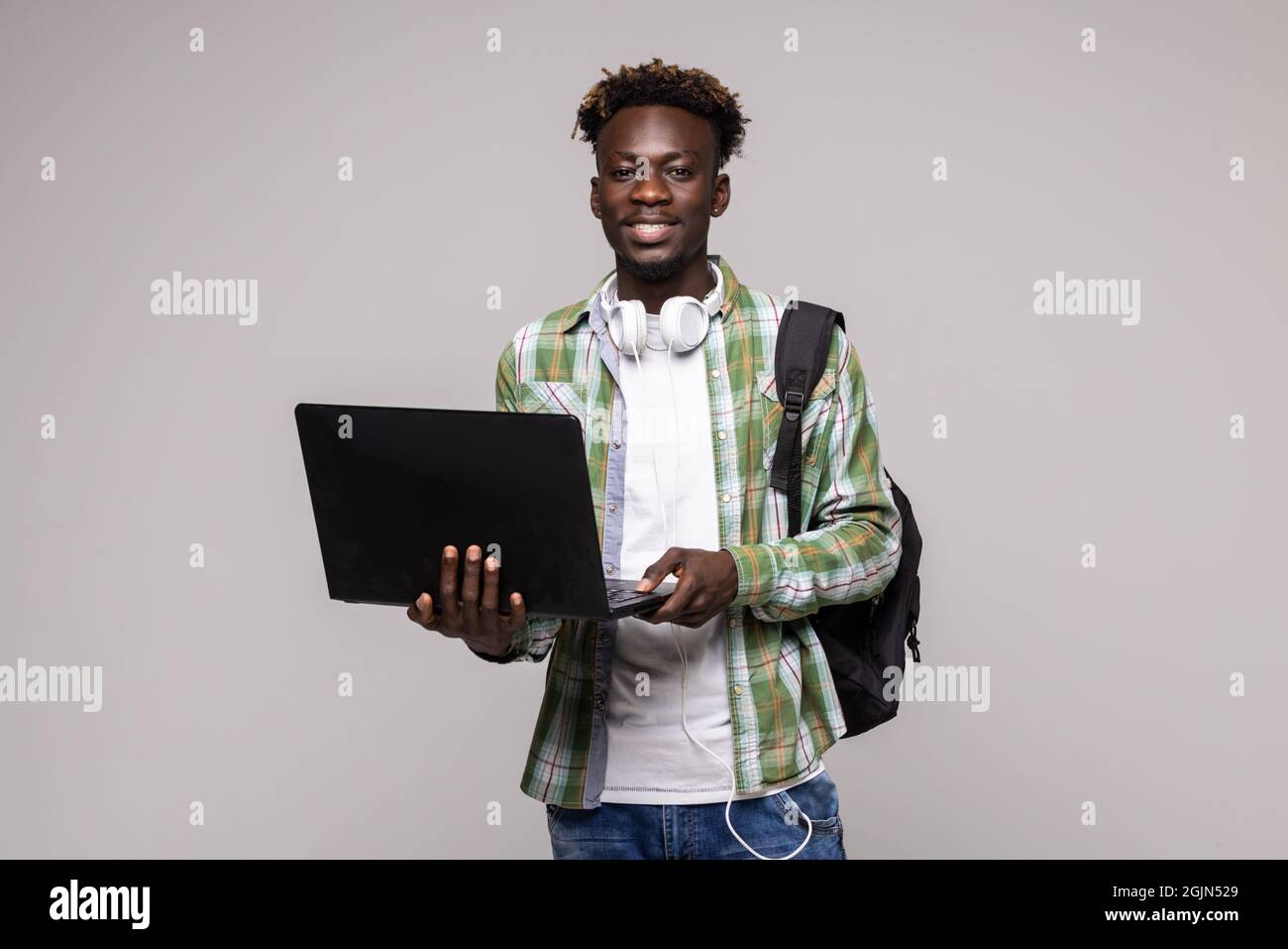Happy college student holding laptop, isolated on white background ...