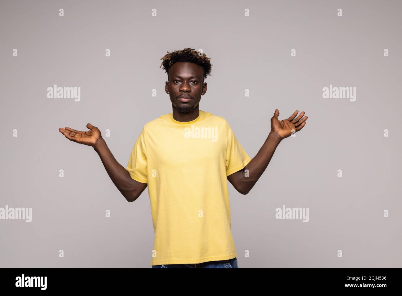 Portrait of young african american man choosing between 2 different ...