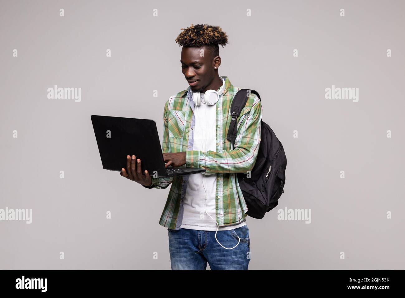 Happy african american student holding laptop on white Background Stock ...