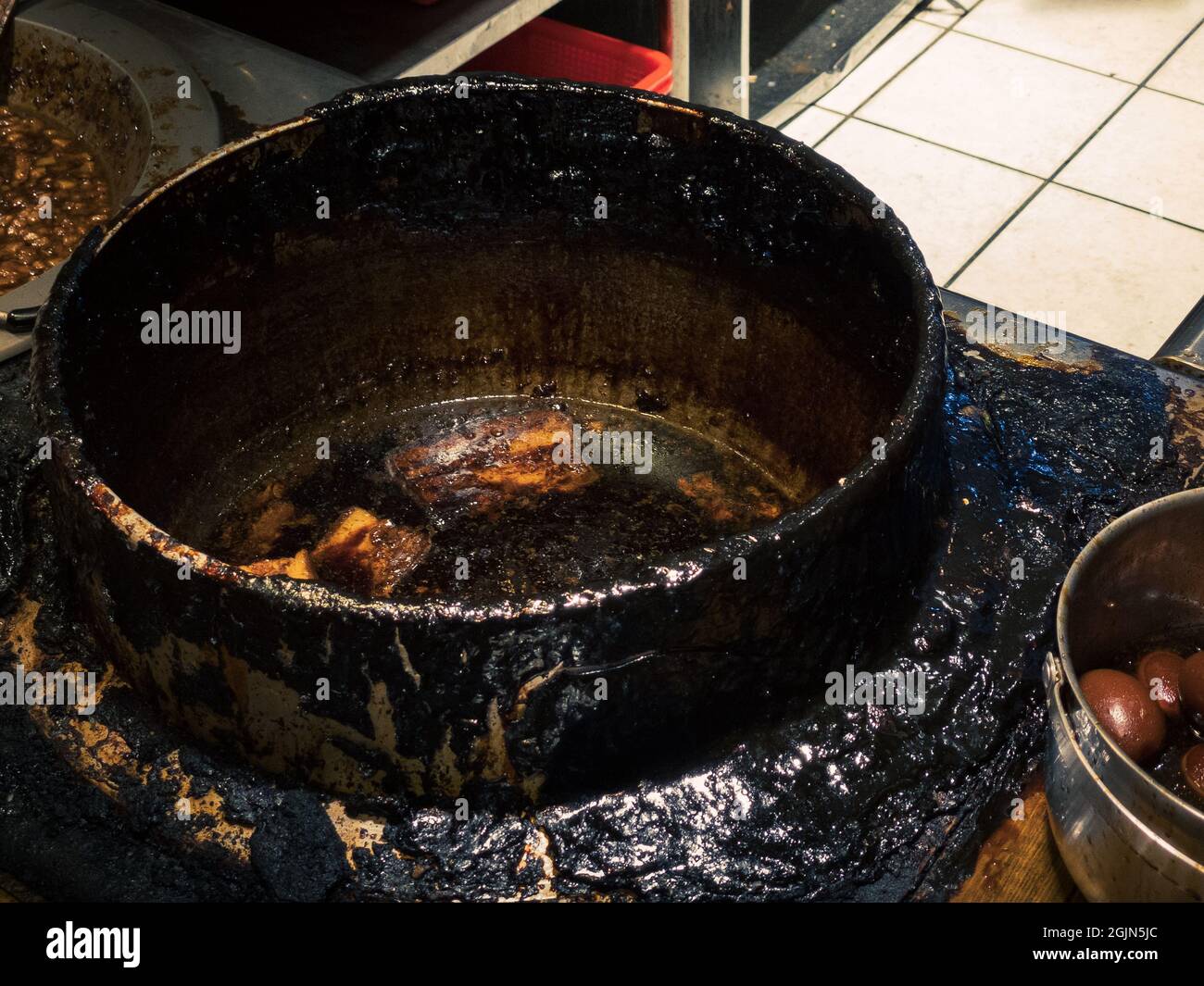 Braised pork belly on dirty braising pot. Prepare for chef cook a slice ...