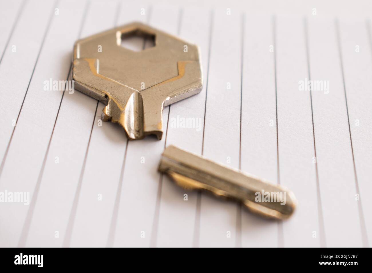 Closeup of a broken key on a lined paper Stock Photo - Alamy