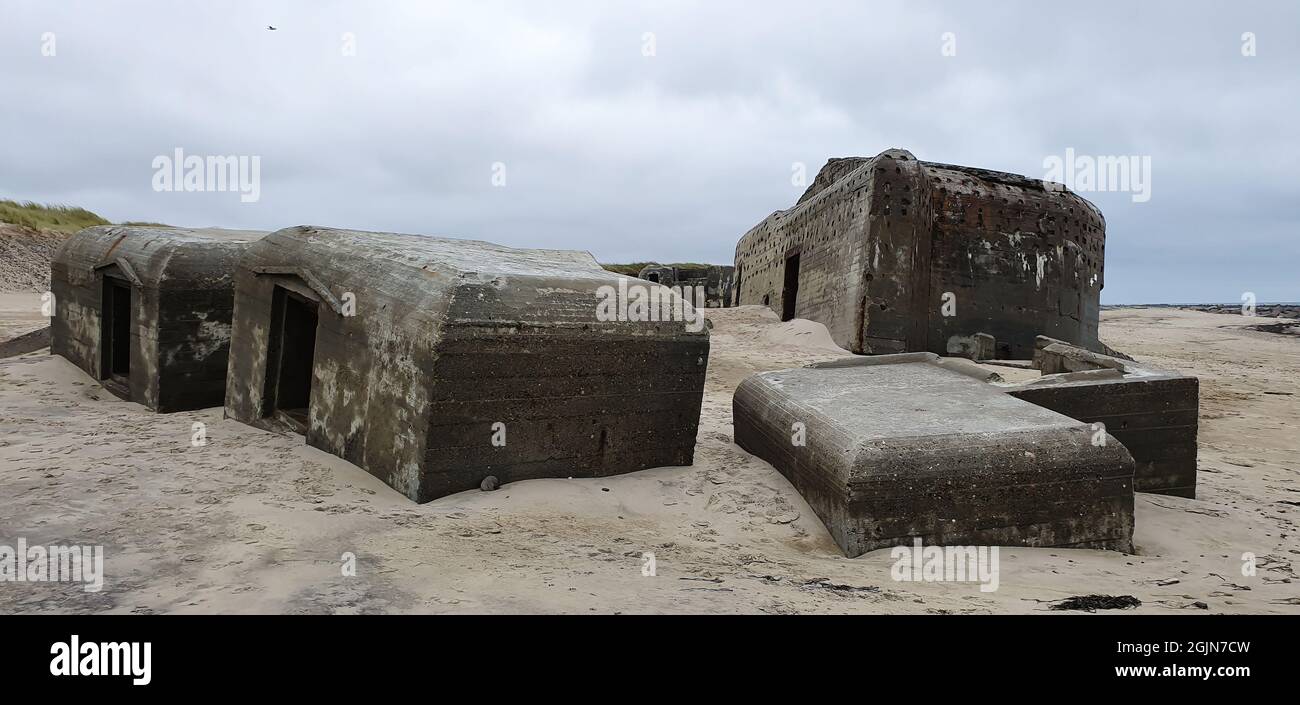 Tranquil scenery of abandoned ruins of old buildings on a sandy beach ...