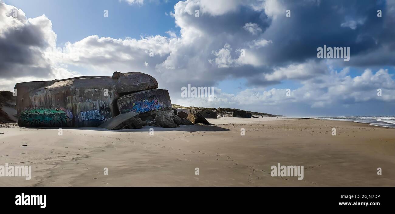 Tranquil scenery of abandoned ruins of old buildings on a sandy beach ...