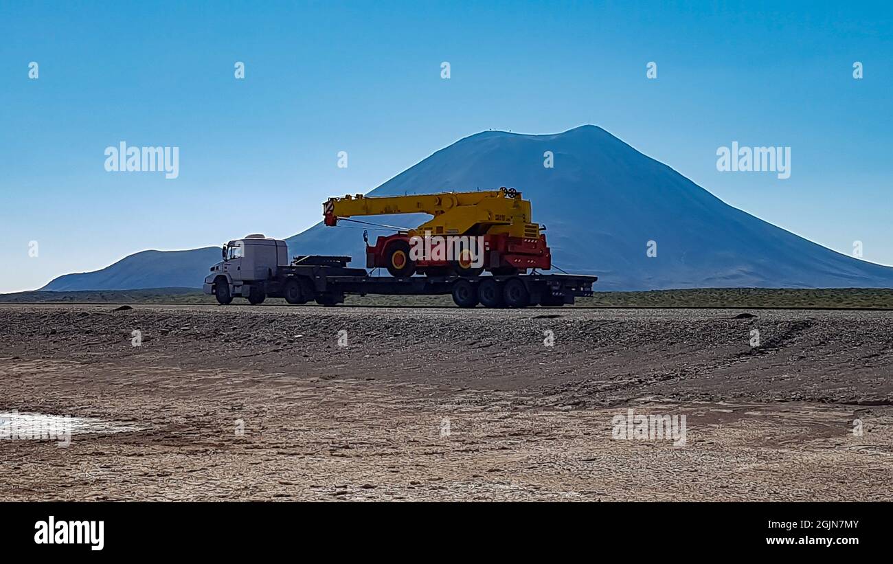 Truck carrying a heavy crane driving on the construction site Stock ...