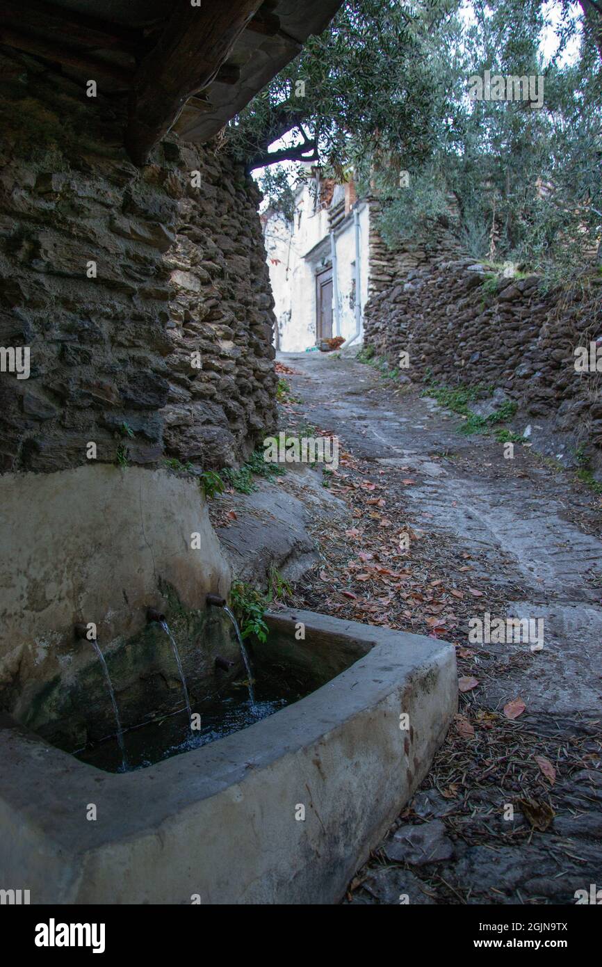 Alpujarra stone fountain located at the beginning of a street slope ...