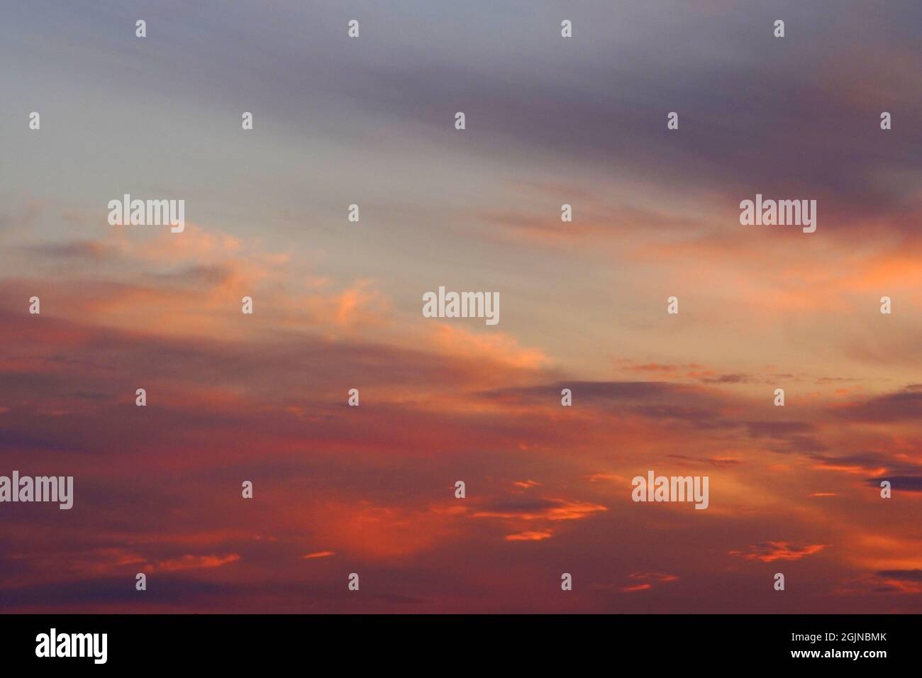 Colorful fine fluffy clouds on blue sky at sunset. Mix of bright and ...