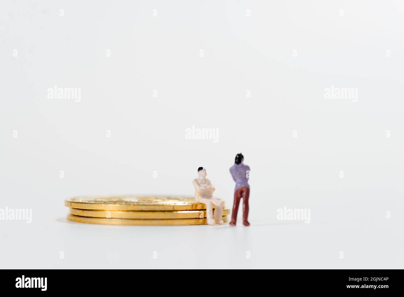 A human figure sitting on a crypto currency and talking with a another ...