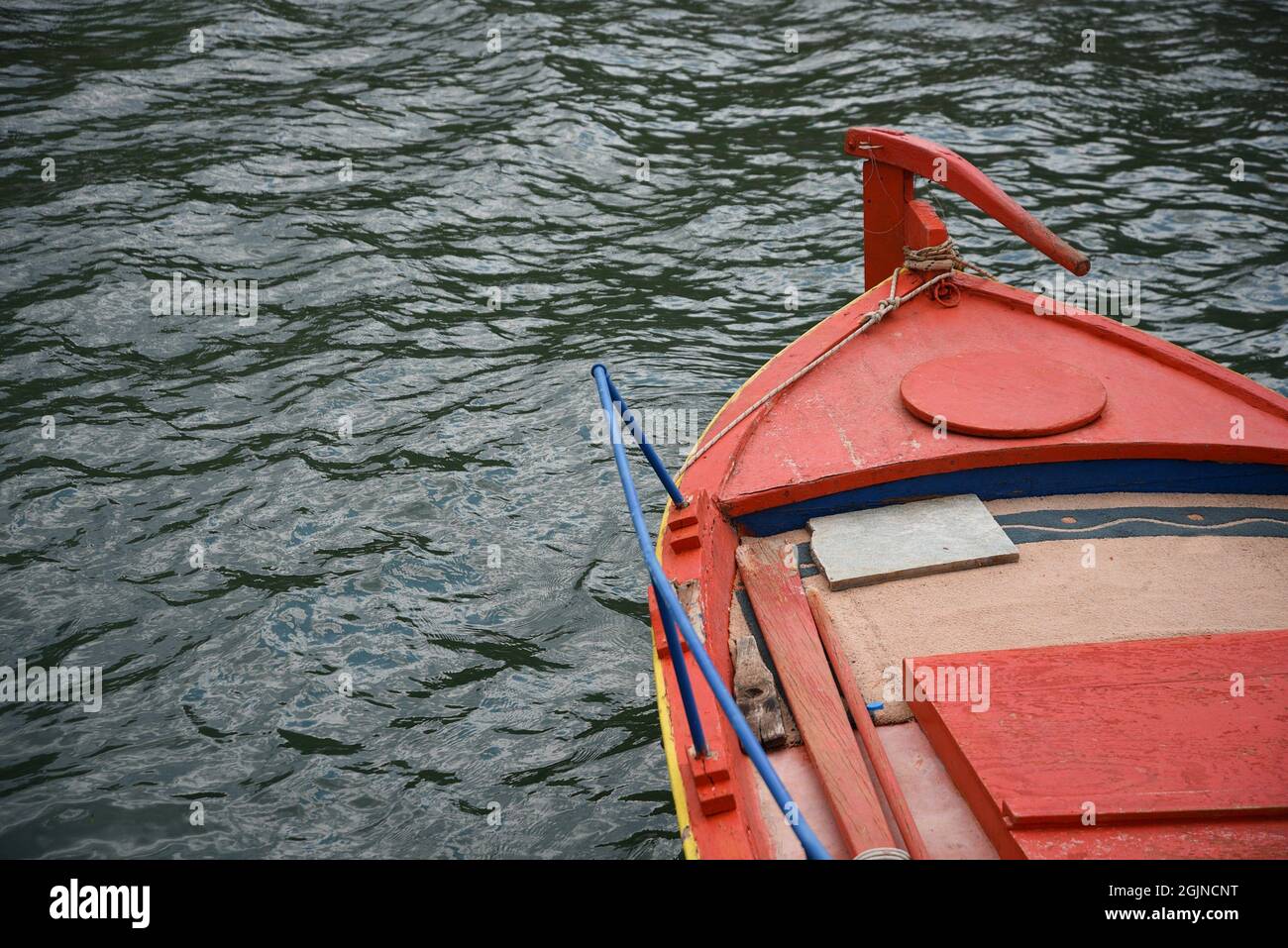 Landscape with scenic view of a traditional Greek fishing boat bow on ...