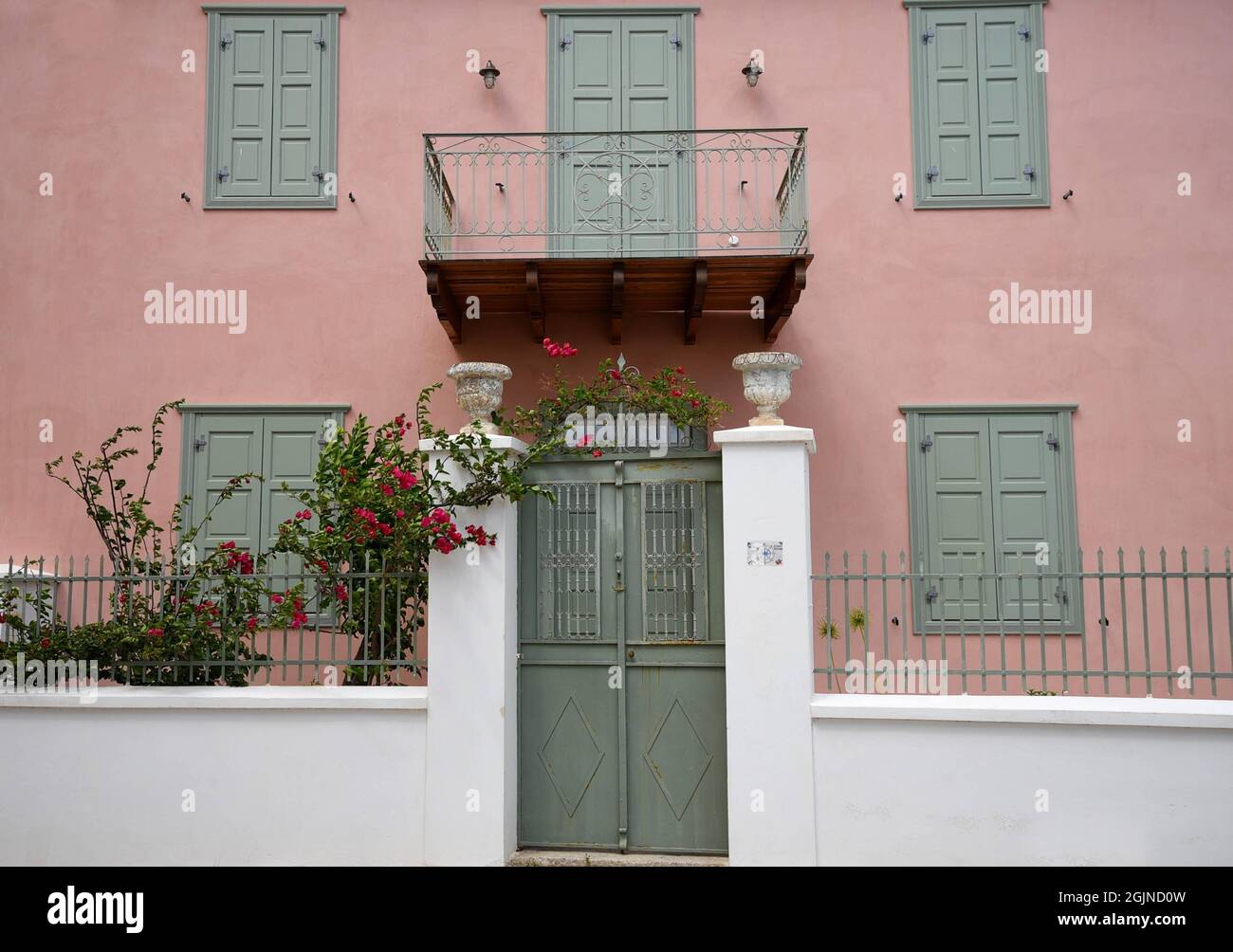 Neoclassical house facade with a Venetian salmon pink stucco wall and ...