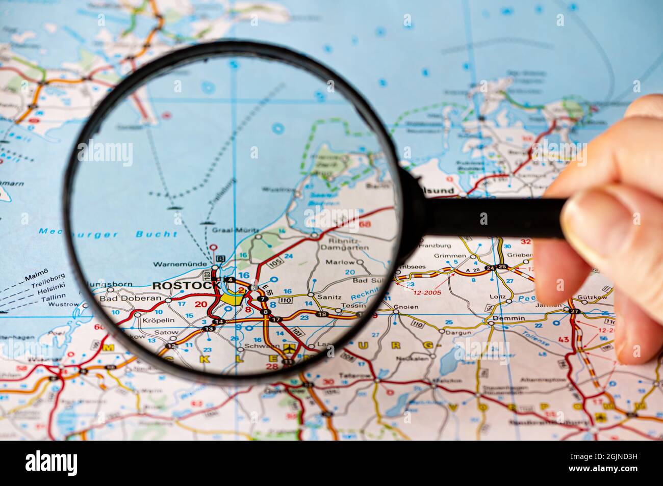 map of Rostock in Germany through magnifying glass, concept of planning ...