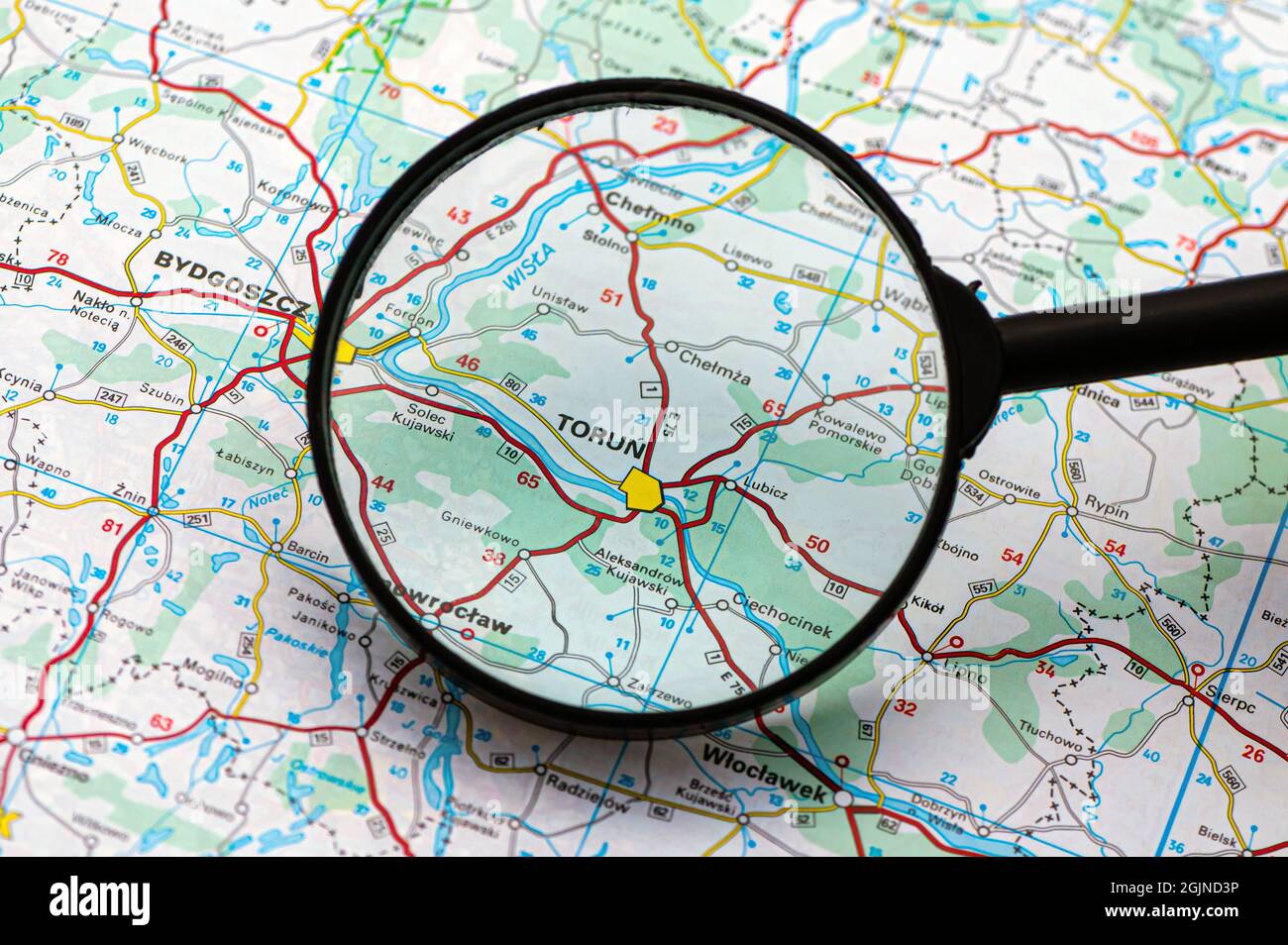 map of Torun in Poland through magnifying glass, concept of planning ...