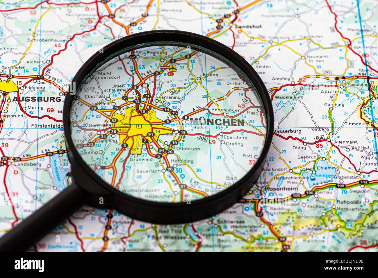 map of Munchen in Germany through magnifying glass, concept of planning ...