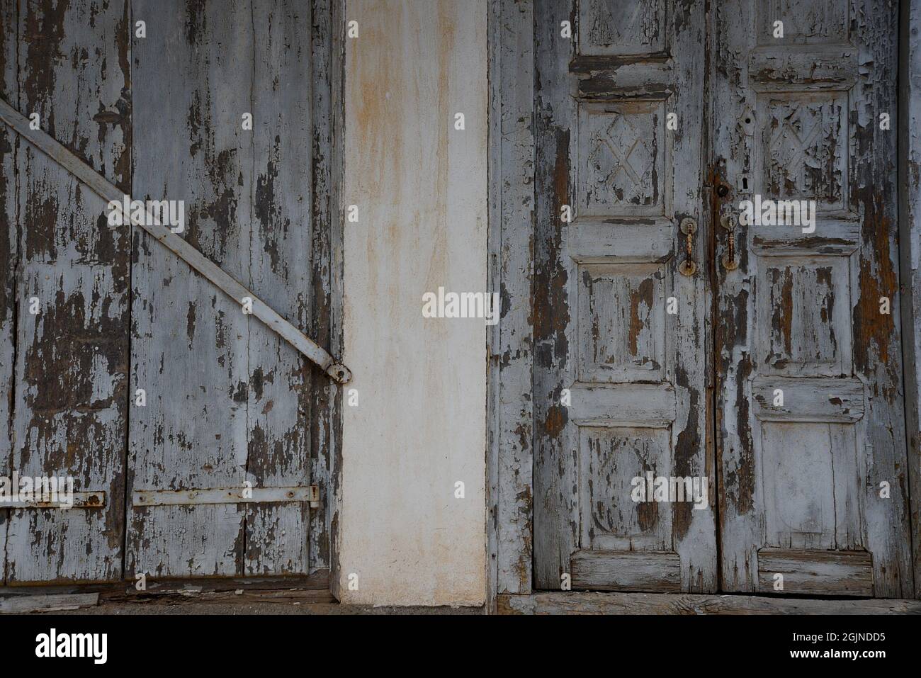 Old traditional rural house faded grey wooden window shutters on a ...