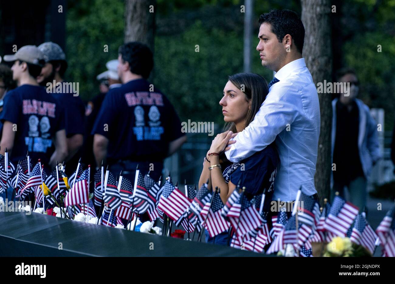 New York City, USA. 11th Sep, 2021. Katie Mascali is comforted by her ...