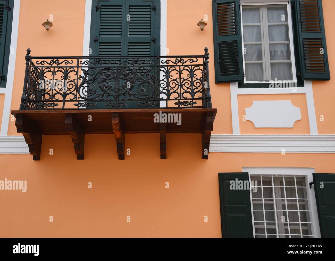Neoclassical house facade with a Venetian stucco wall, cypress green ...