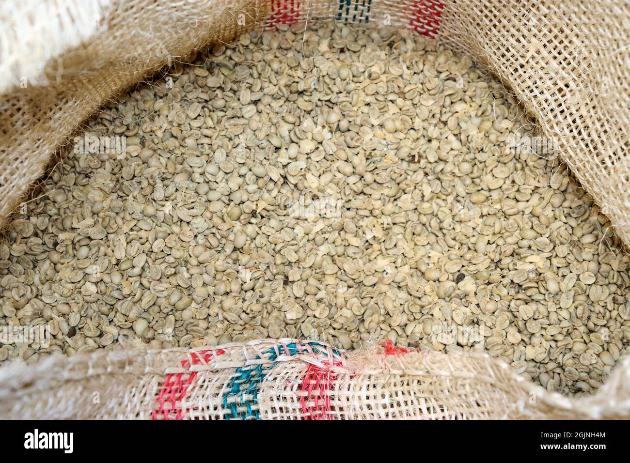 A coffee roasting factory scene with large burlap sacks filled with ...