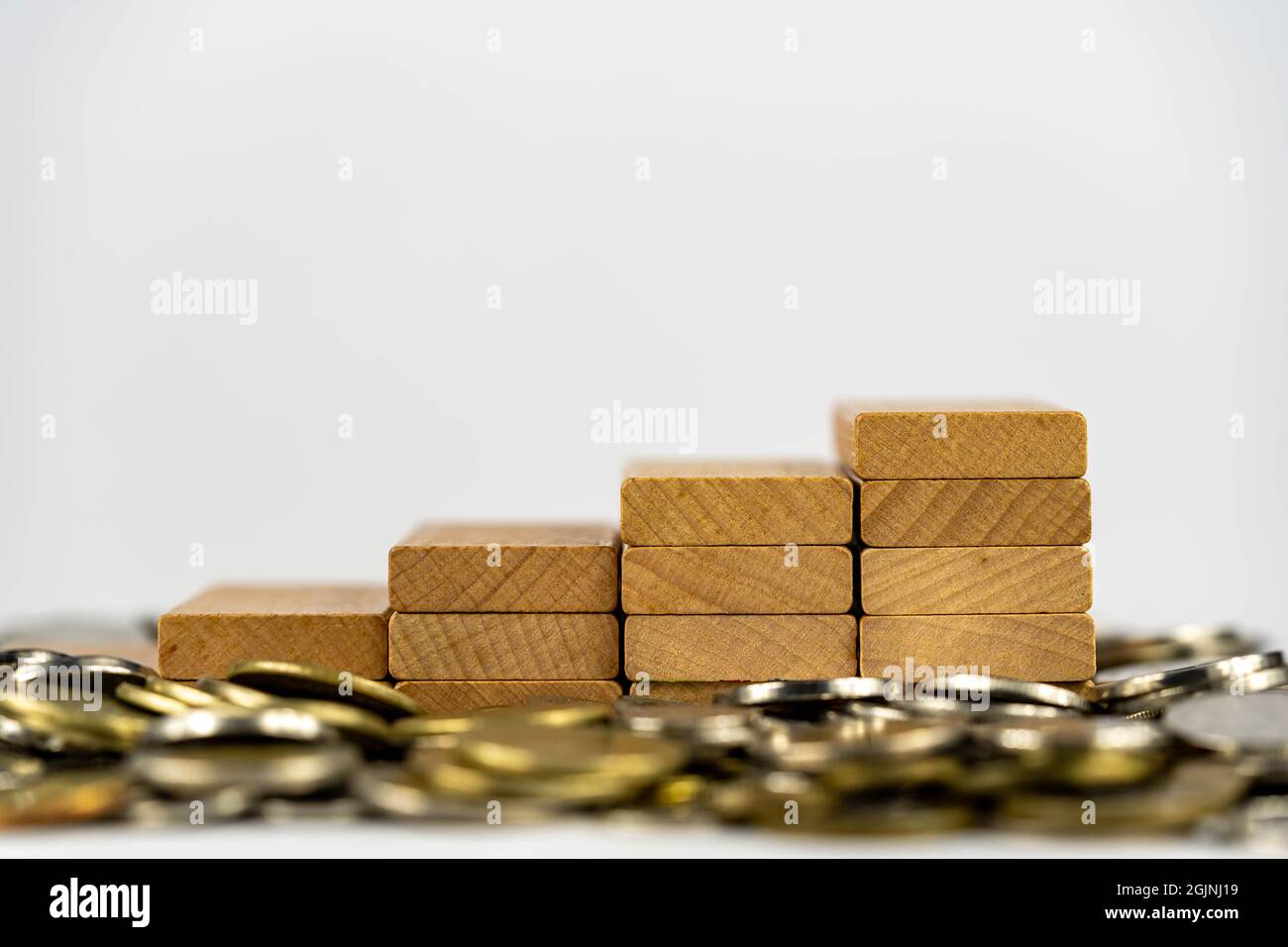 Coins scattered on wooden stairs. Financial concept. Savings Concepts ...