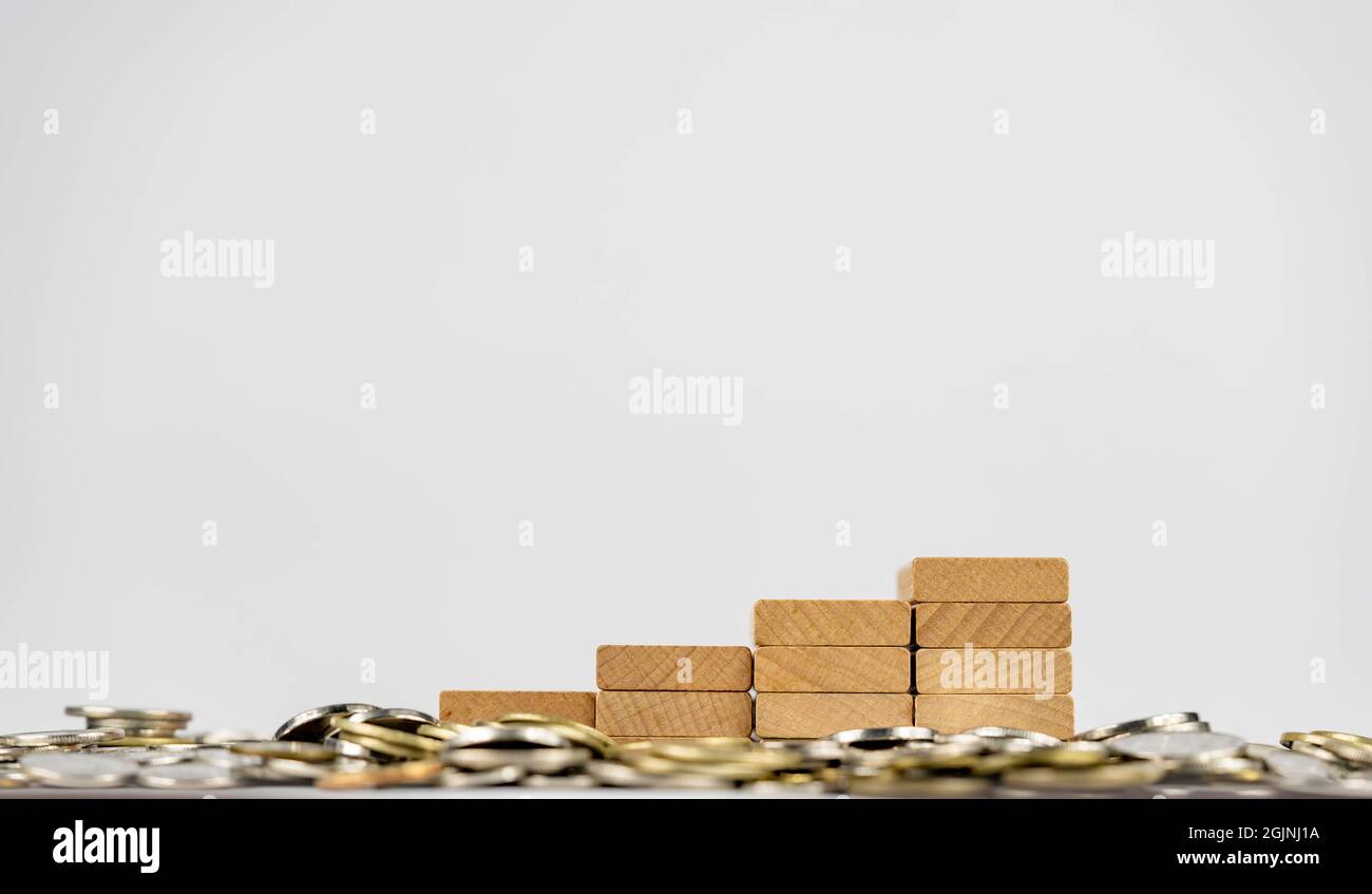 Coins scattered on wooden stairs. Financial concept. Savings Concepts ...