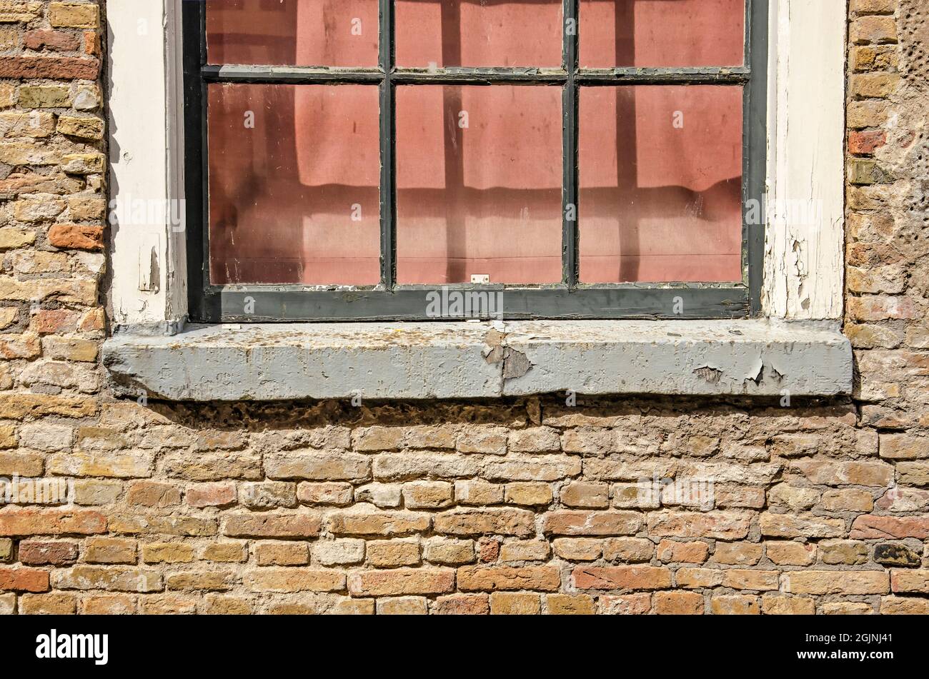 Old and rough brick facade with a somewhat dilapidated window Stock ...