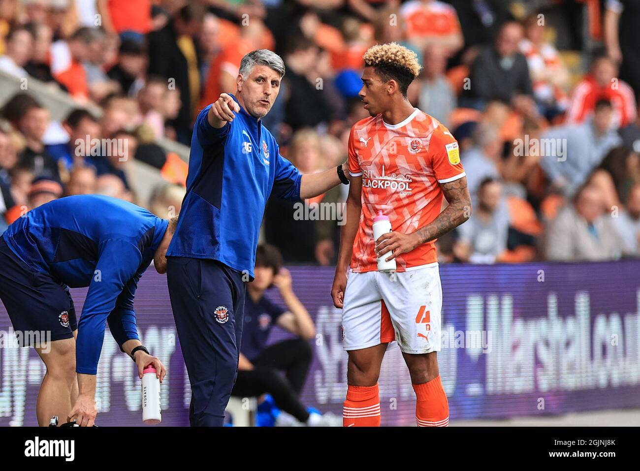 Mike Garrity coach of Blackpool gives instruction to Jordan Gabriel #4 ...
