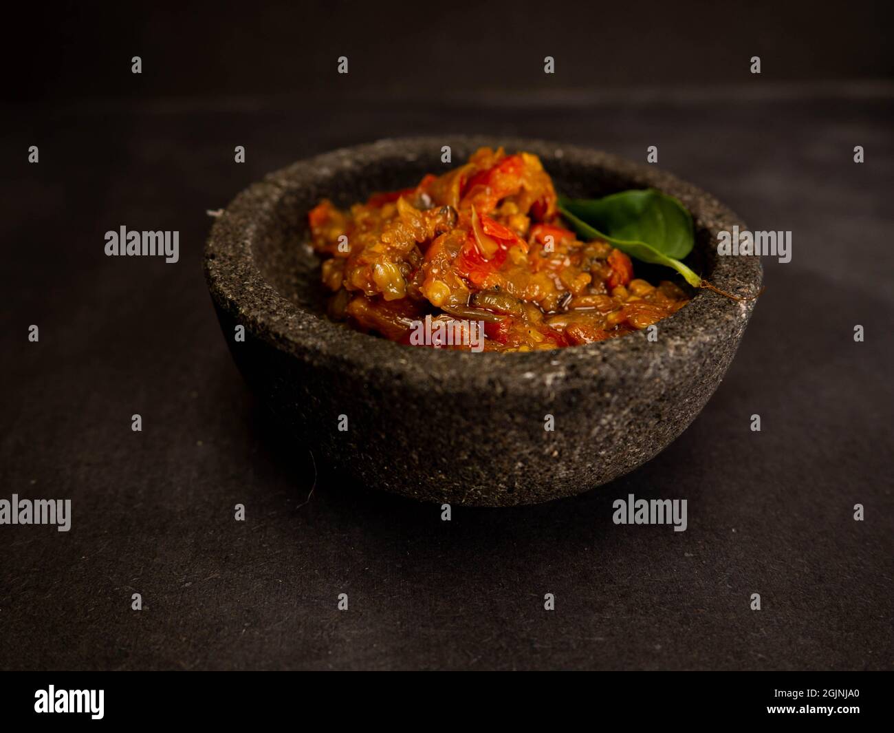 Pictures of 'sambal' an Indonesian spicy food on a stone bowl. Shoot on ...