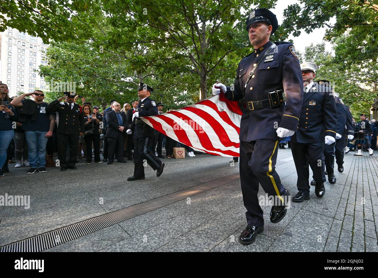 New York City, USA. 11th Sep, 2021. Members of the NYPD carry a frayed ...