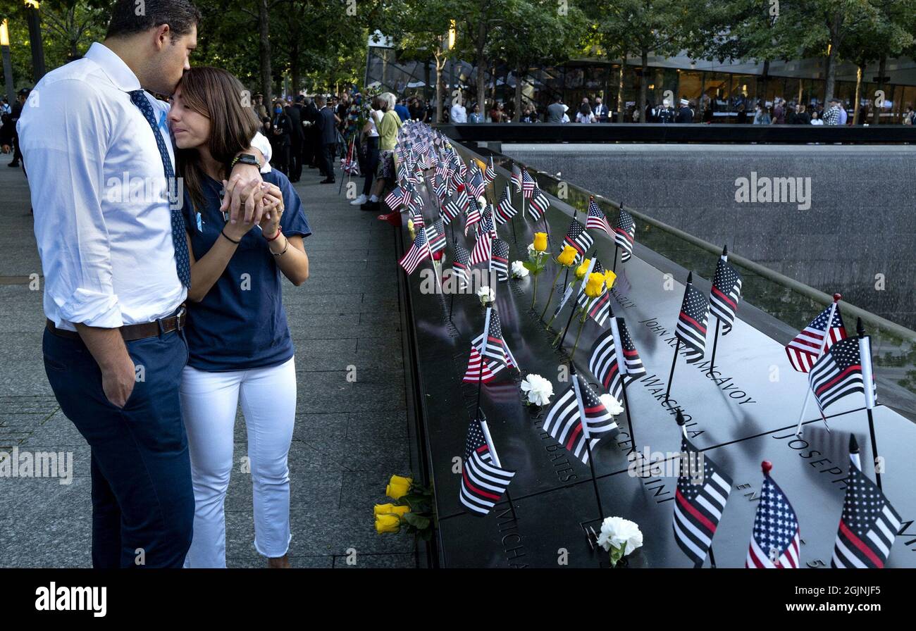 New York City, USA. 11th Sep, 2021. Katie Mascali is comforted by her ...
