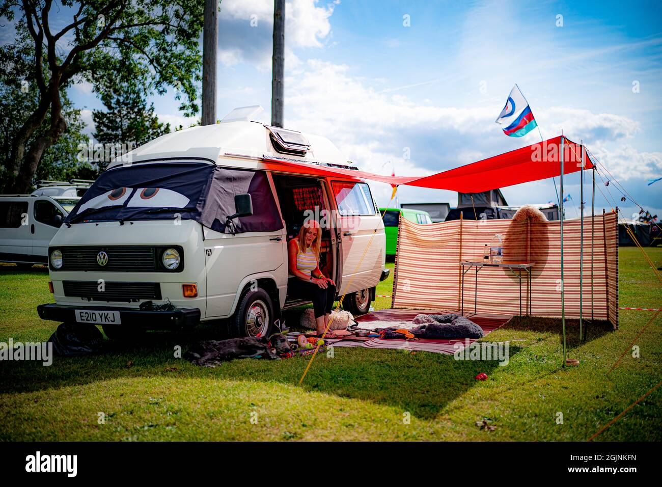 A camper relaxes inside her VW T2 'Wedge' van at Busfest at Malvern ...