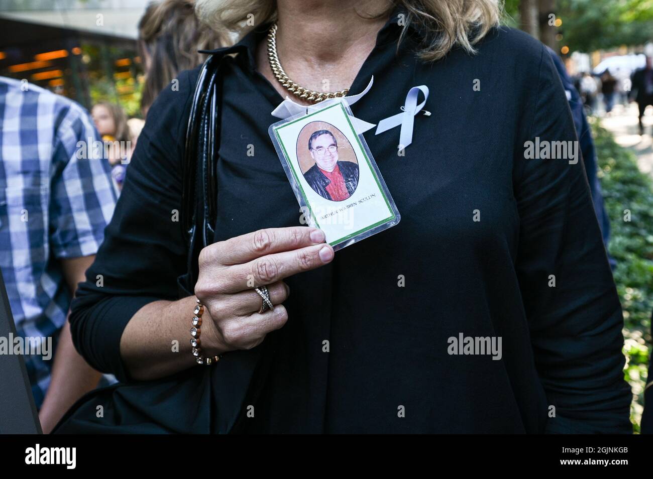 New York, USA. 11th Sep, 2021. A woman holds a placard with the picture ...