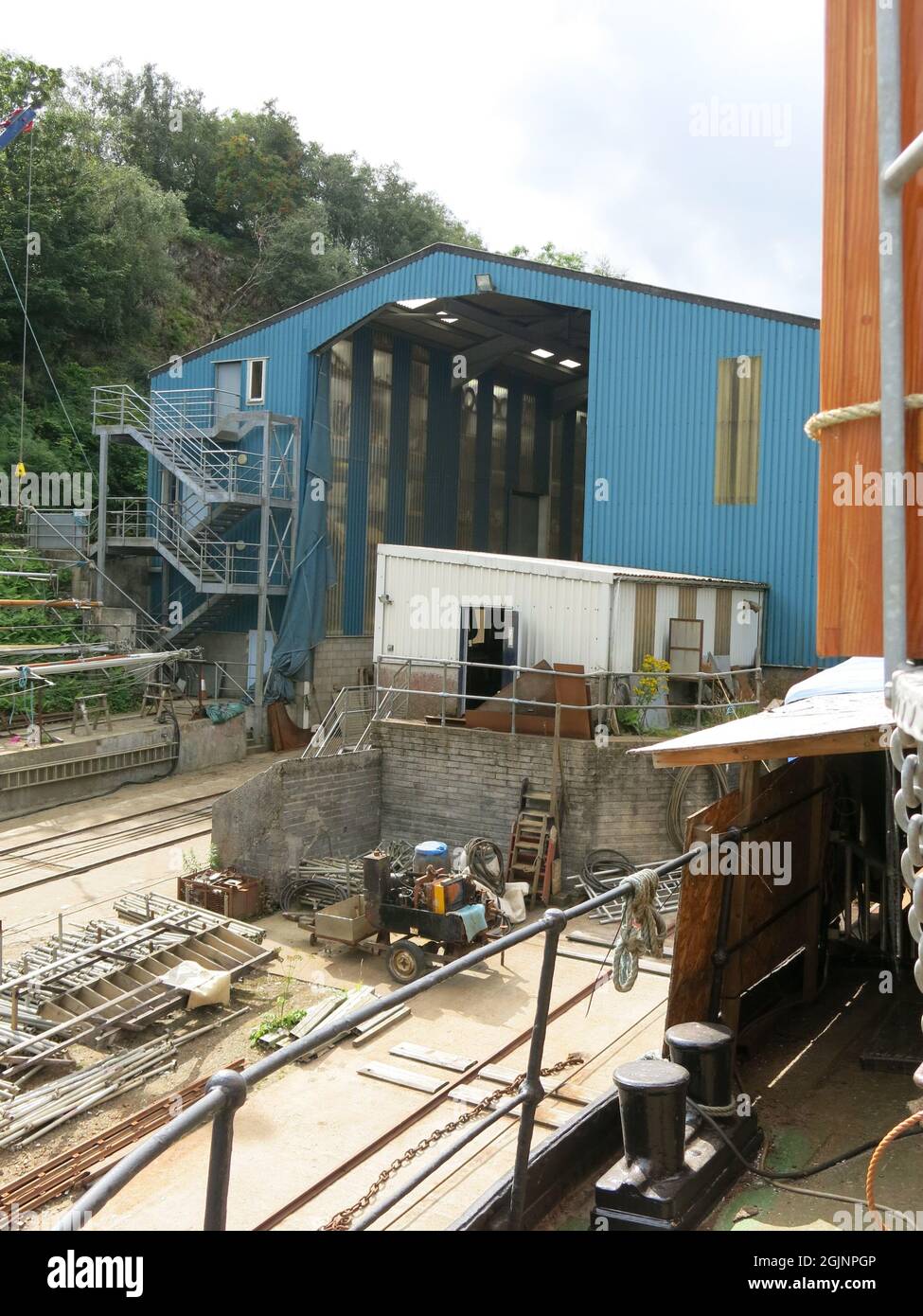 View of the large blue shed at Crinan Boatyard where shipbuilding ...