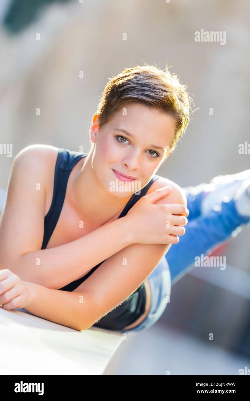 Blonde fairhaired sdolescent teen laying down on her tummy belly stomach Stock Photo - Alamy